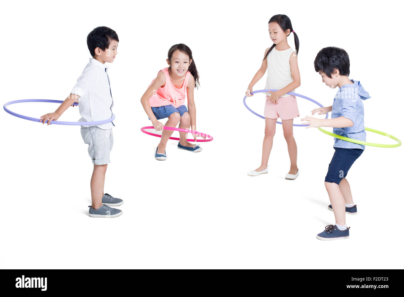 Happy children spinning plastic hoops Stock Photo - Alamy