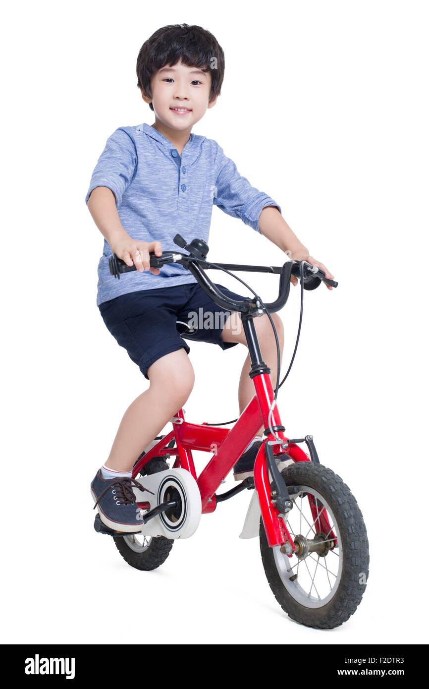 Boy riding bicycle playing Cut Out Stock Images & Pictures - Alamy