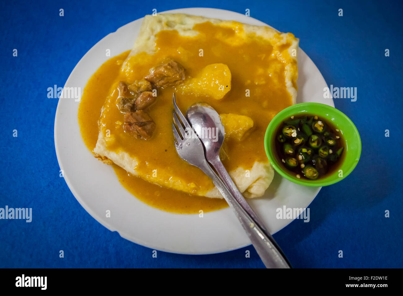 Palembang-style of martabak (pan-fried stuffed bread) with sauce, meat ...