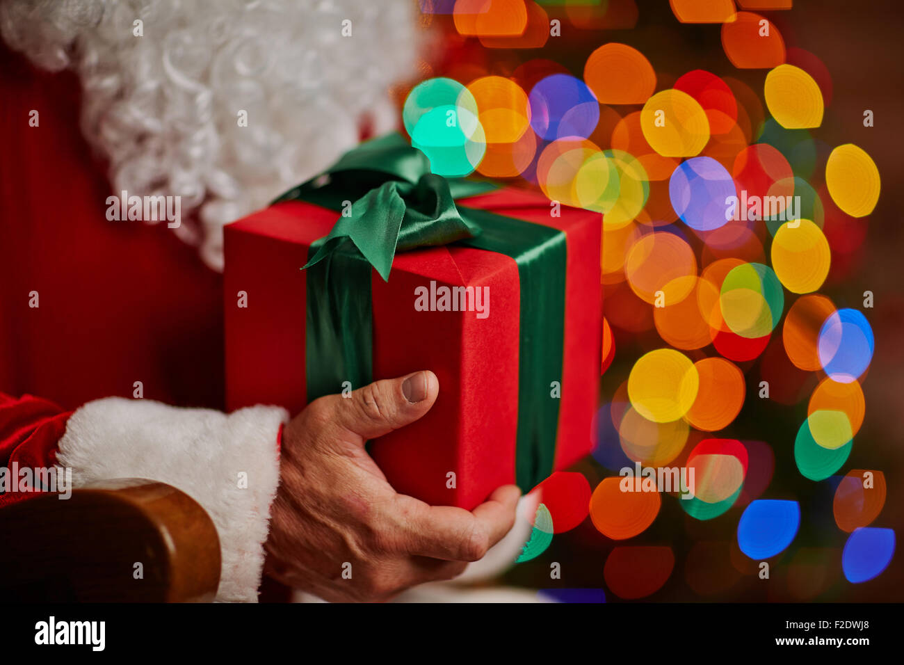 Red box with Christmas gift in Santa hands Stock Photo - Alamy