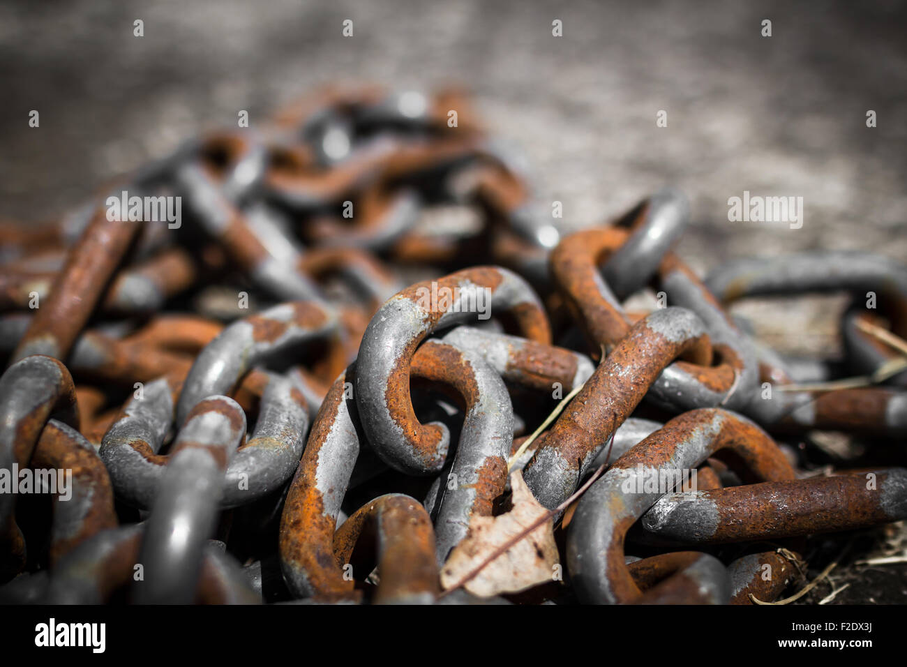 A pile of rusty chains, abandoned on the road Stock Photo - Alamy