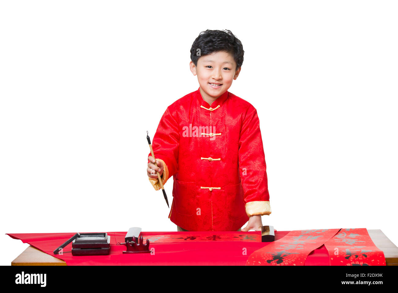 Happy boy writing calligraphy on couplets Stock Photo - Alamy
