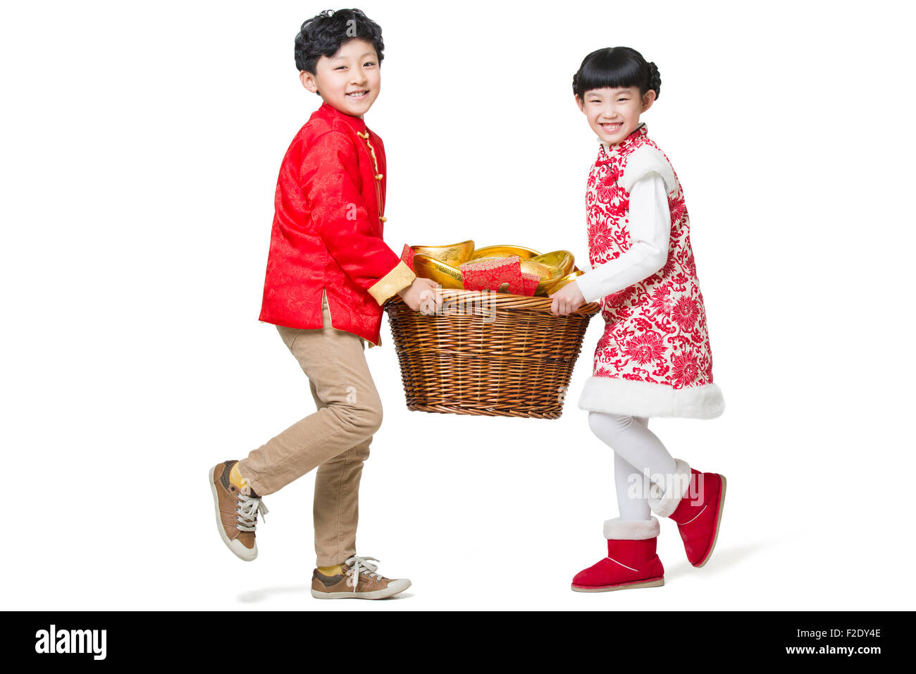 Happy children carrying red envelopes and Chinese traditional currency ...