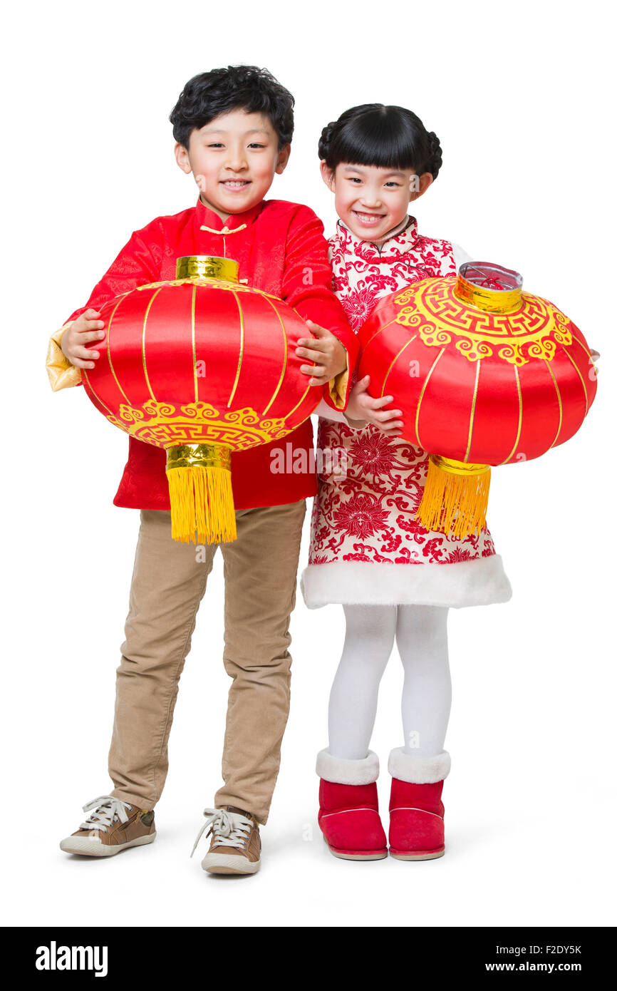 Happy children celebrating Chinese new year with traditional lanterns ...