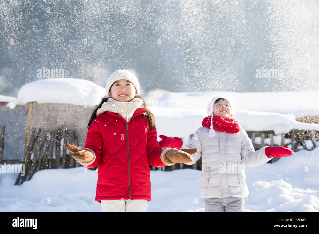 Two girls catching the falling snow together Stock Photo - Alamy