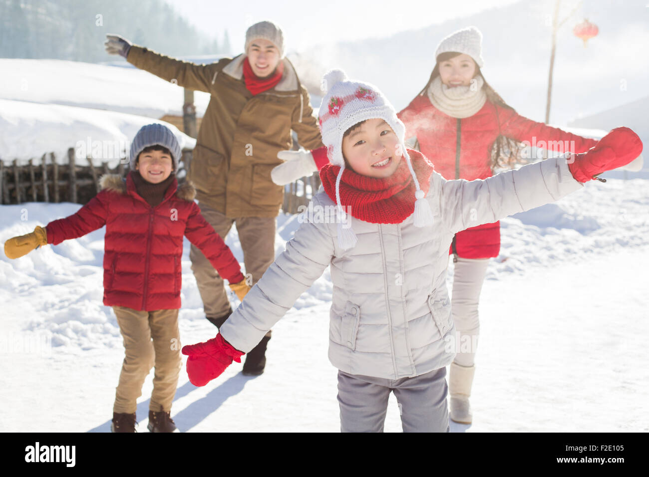 Happy family playing in the snow Stock Photo - Alamy
