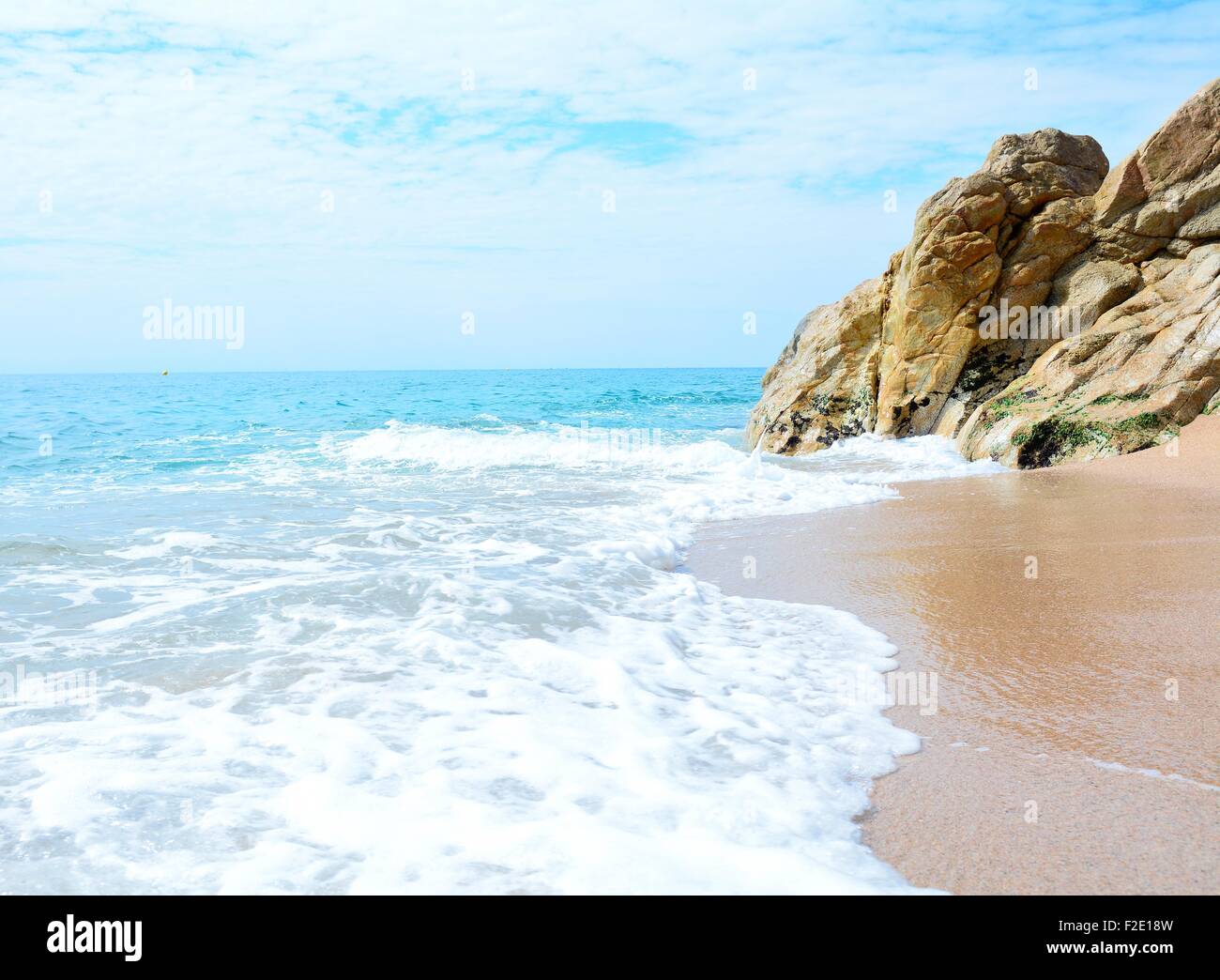 Beautiful beach with clear Mediterranean Sea and rock on the coast ...