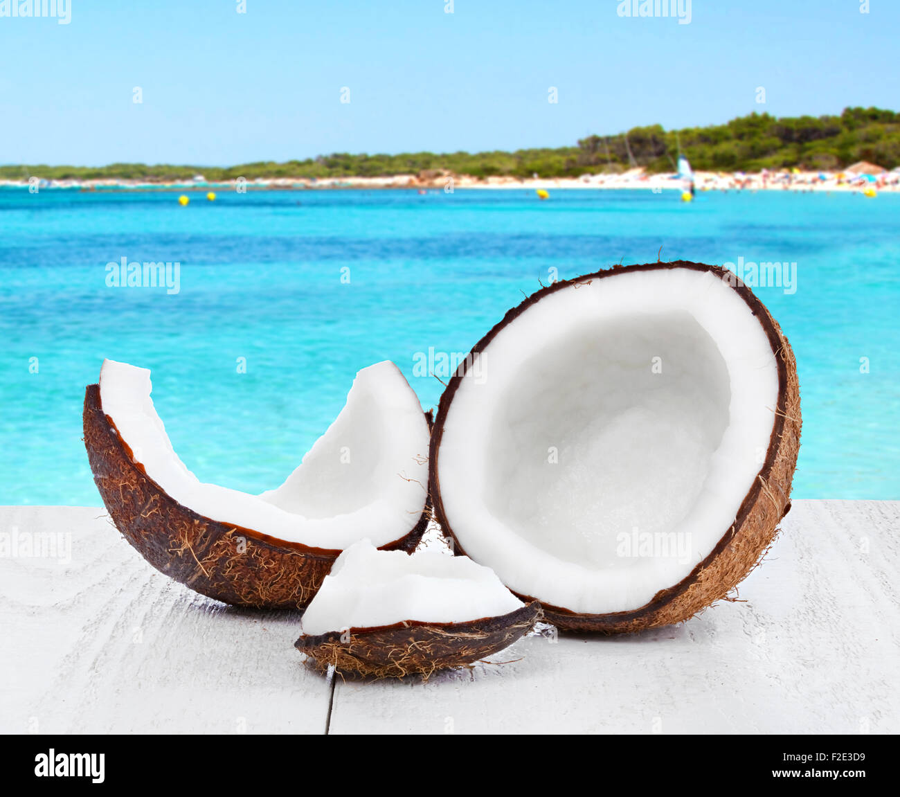 Coconut on white wooden table and beautiful seascape background Stock ...