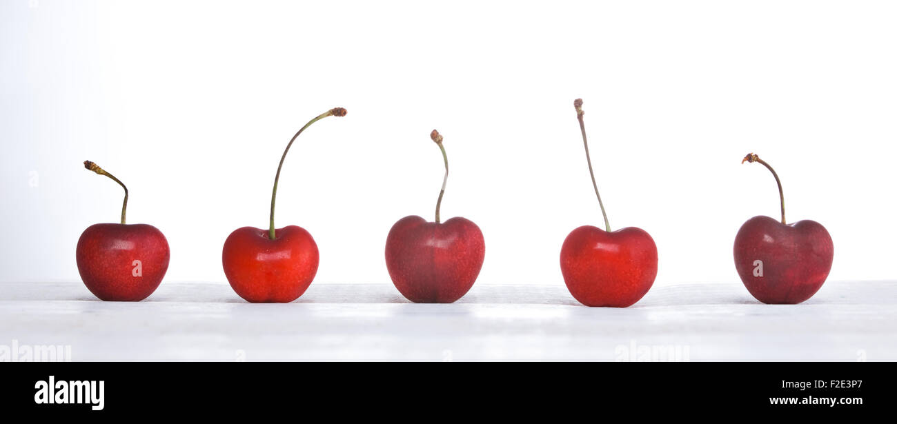Row of freshly cherries on white background Stock Photo - Alamy