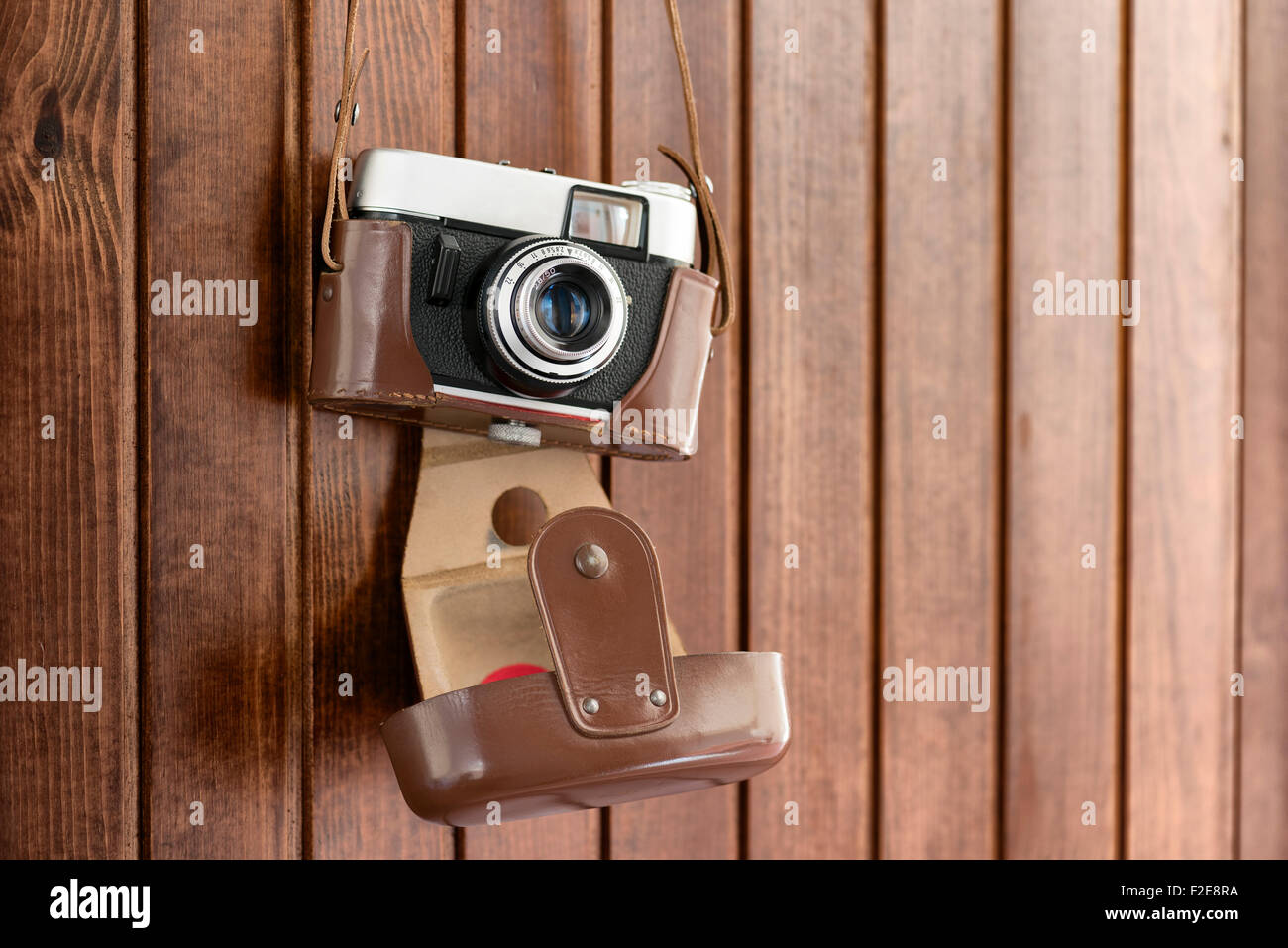old camera hanging on wooden wall Stock Photo - Alamy