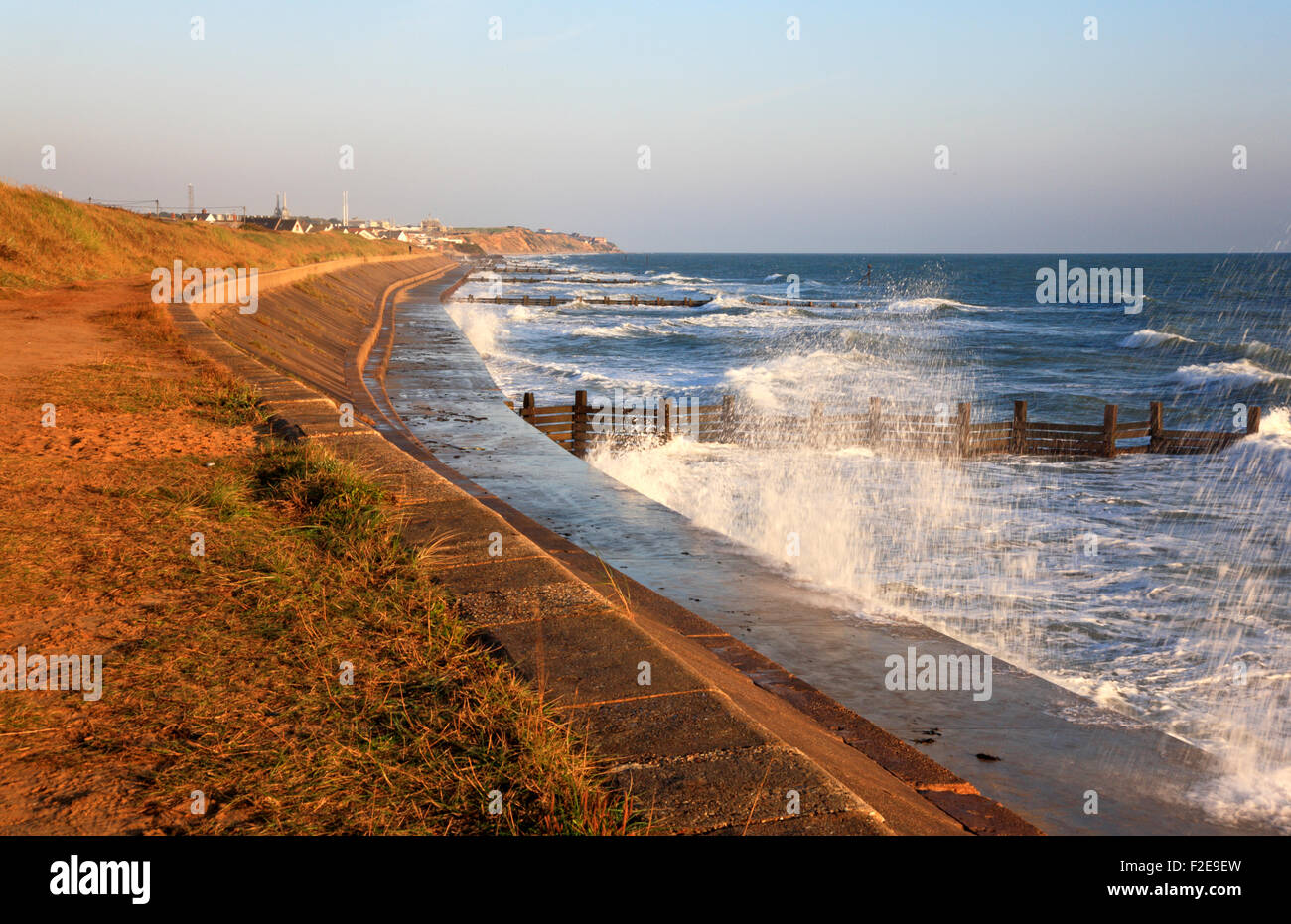A view along the sea wall with a high tide at Bacton-on-Sea, Norfolk ...