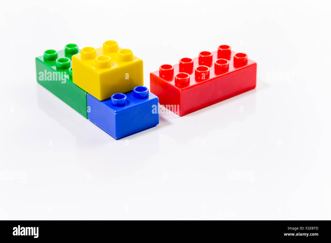 Colorful plastic building bricks on white background Stock Photo - Alamy