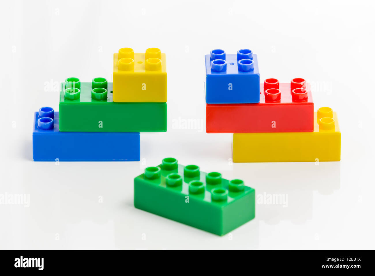 Colorful plastic building bricks on white background, missing link ...