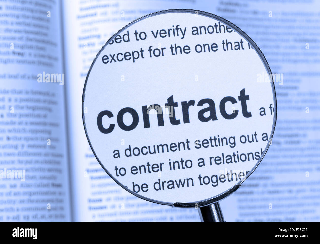 Contract text highlighted through a magnifying glass Stock Photo - Alamy