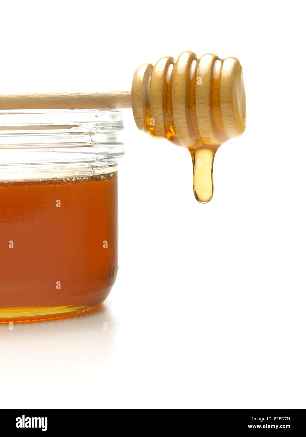 Organic honey dipper isolated drip golden Stock Photo - Alamy