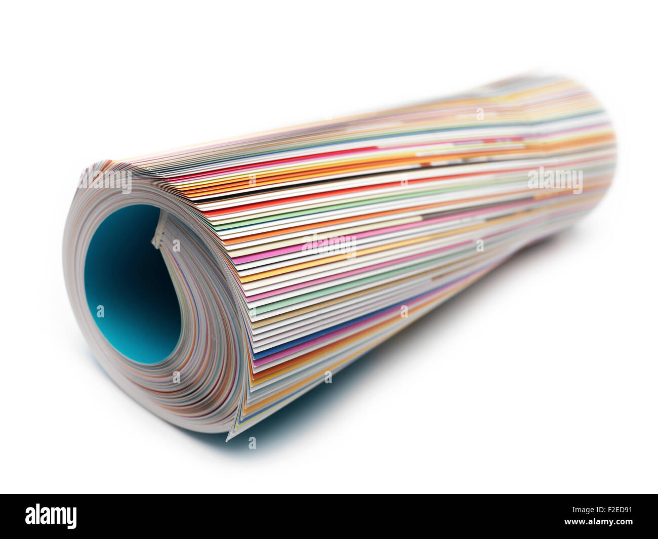 Rolled up magazine on white Stock Photo - Alamy