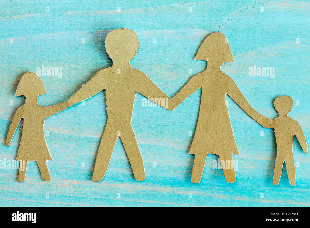 Cardboard figures of the family on a bluewooden background Stock Photo ...