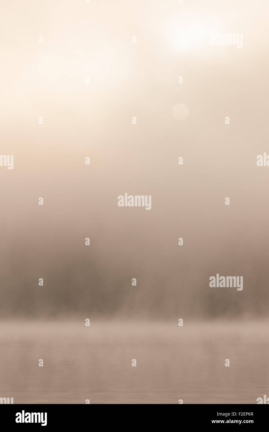 Morning sun through fog at lake Stock Photo - Alamy