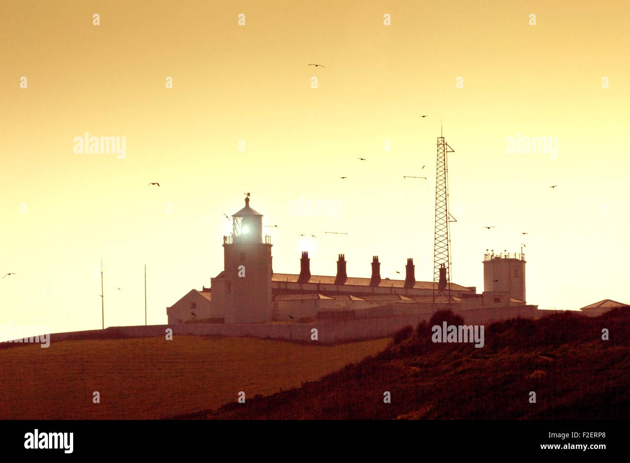 Lizard Point lighthouse with its light flashing on the Lizard Peninsula ...