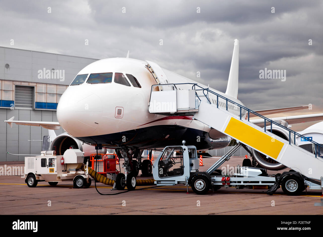 Refueling the airplane in airport and preparing for flight Stock Photo ...