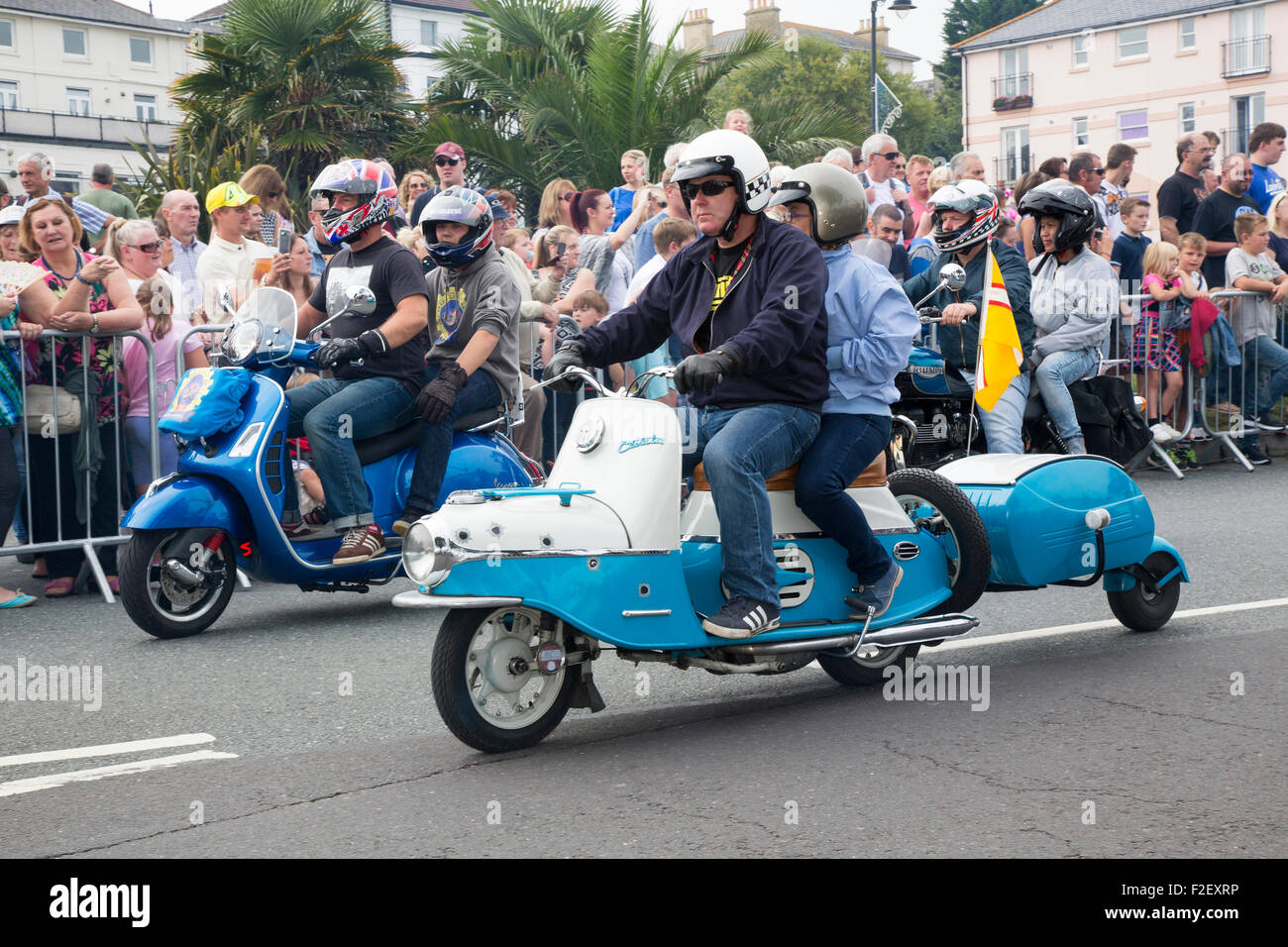 A line-up of motor scooters with happy riders set out on the island ...