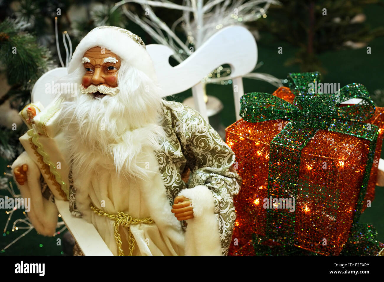 Toy Santa Claus with gifts on white sledge Stock Photo - Alamy