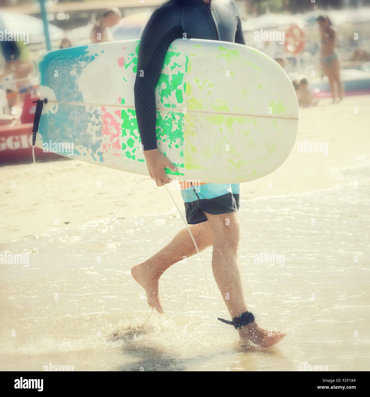 Surfer ready to enter the water for surfing Stock Photo - Alamy