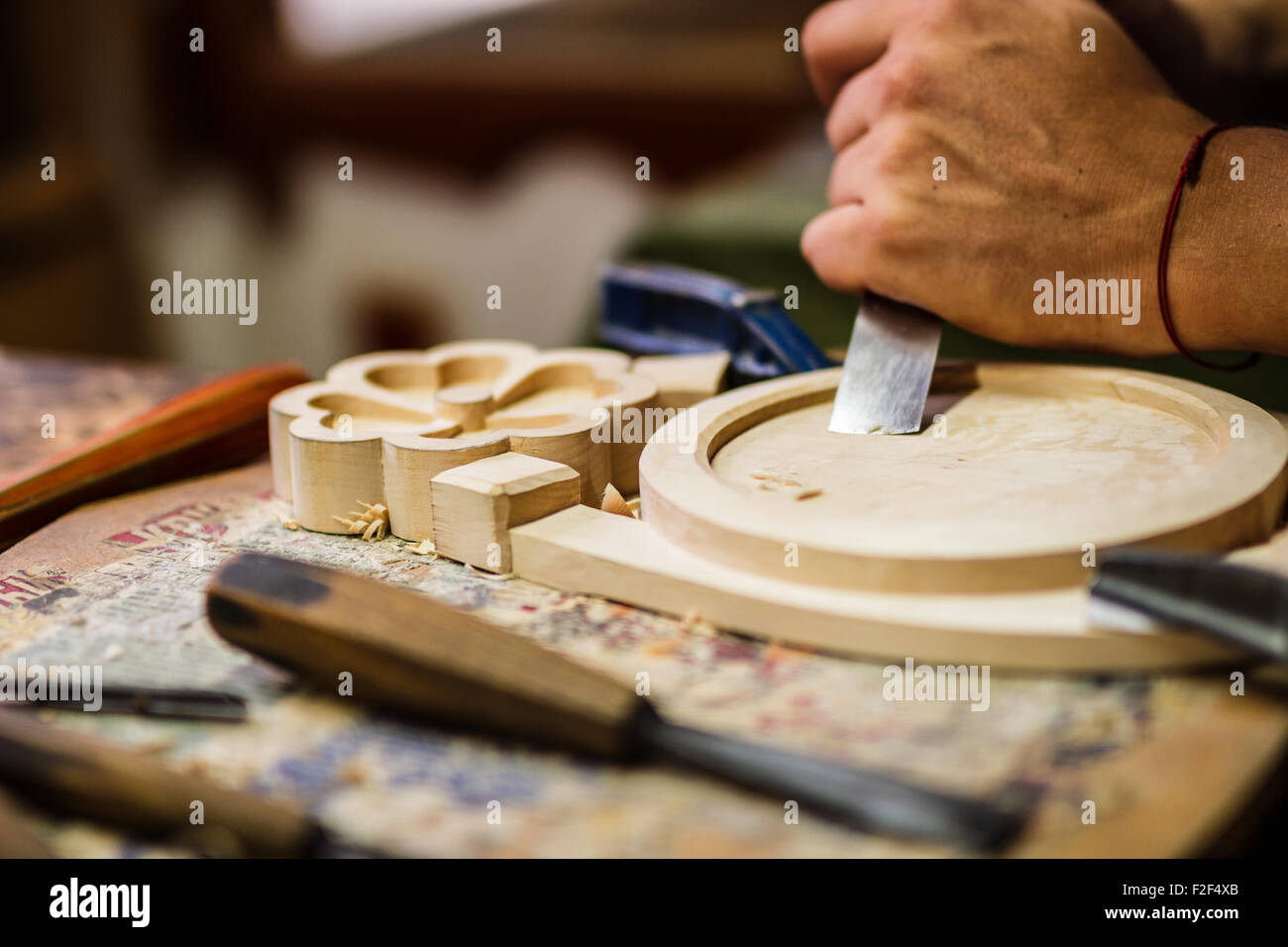 Carpenter hand carving wood with care. Hand with tool blured in motion ...