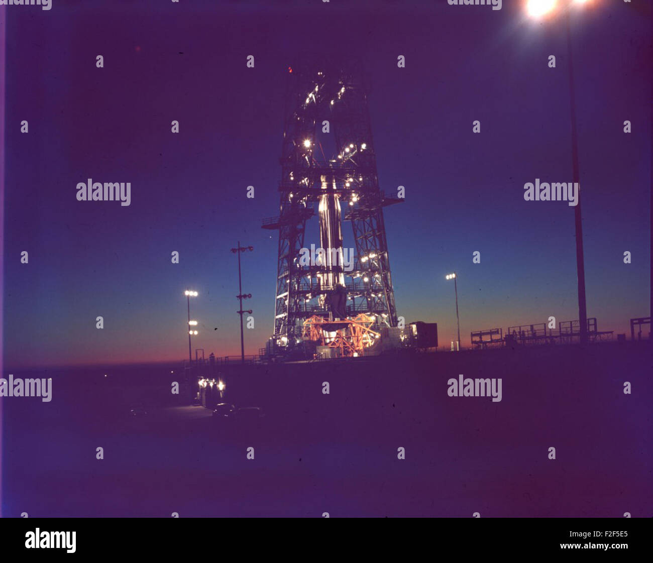 The Atlas 1D rocket is shown in the gantry at night, with a sunset view ...