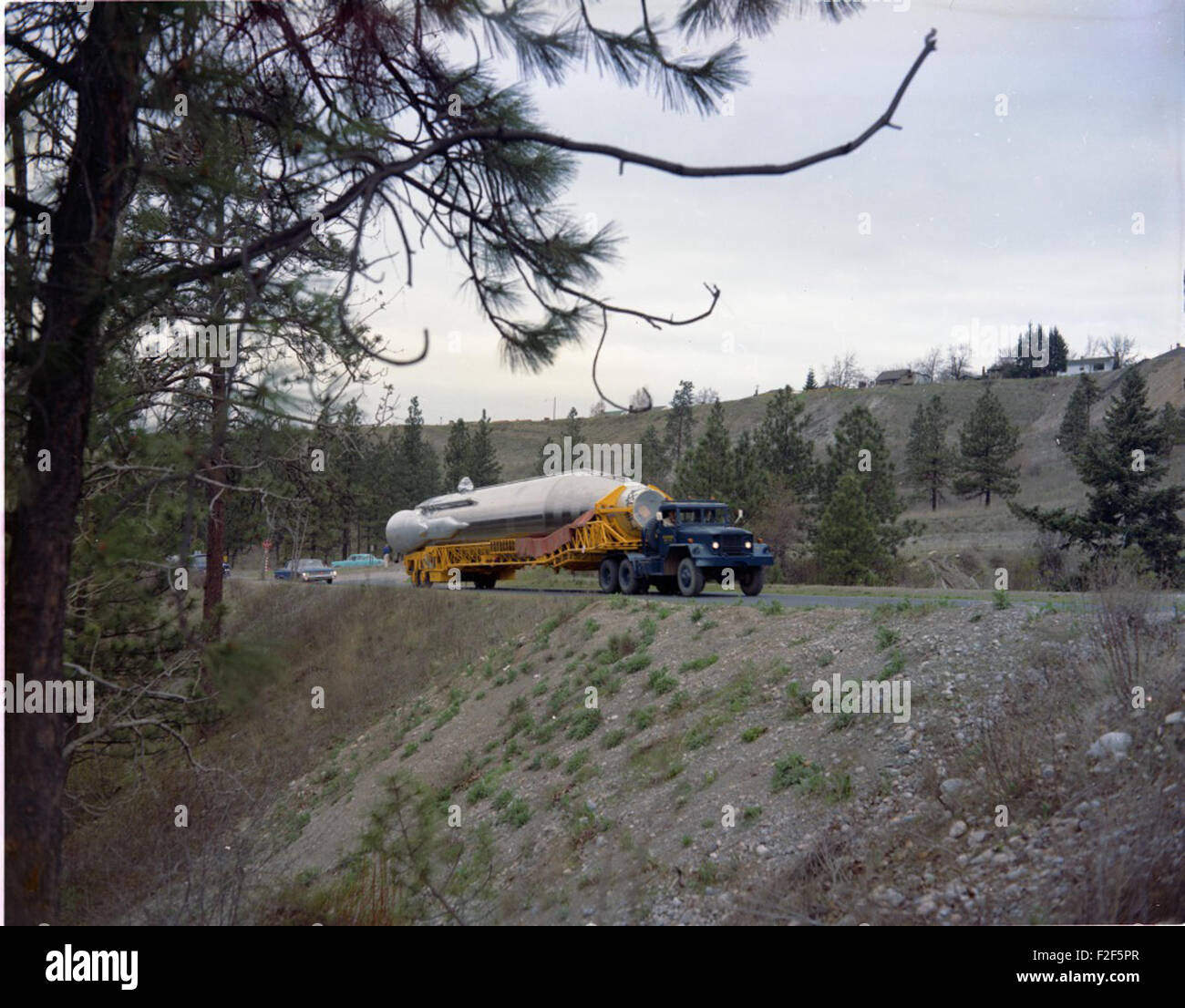 The Atlas 20E missile is shown being transported along a highway on ...