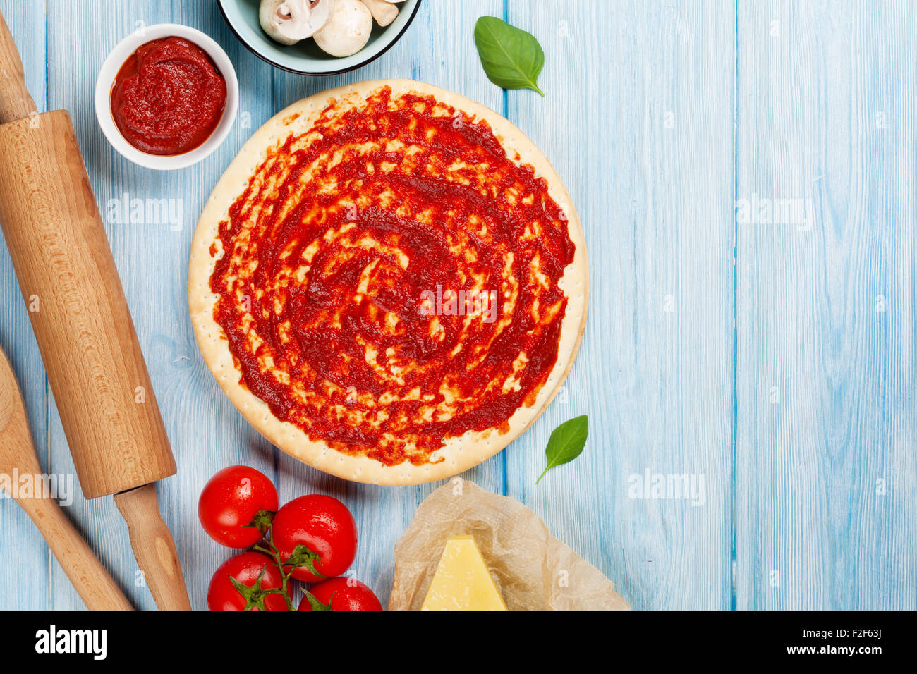 Pizza cooking ingredients. Dough, vegetables and spices. Top view with ...