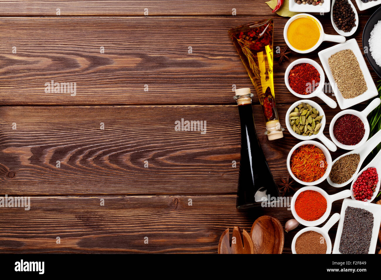 Various spices and condiments on wooden background with copy space ...