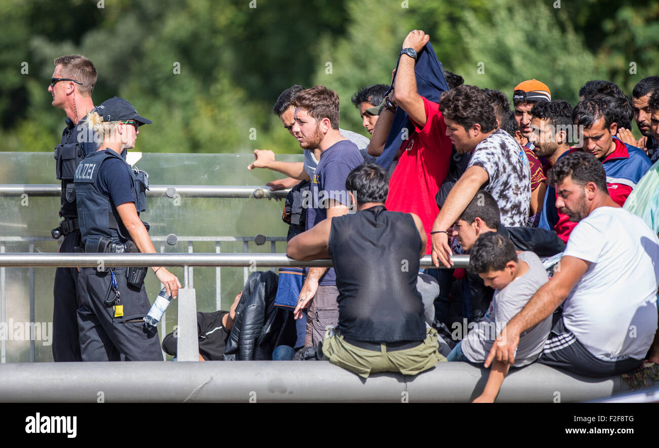 Freilassing, Germany. 17th Sep, 2015. Refugees wait to cross into ...