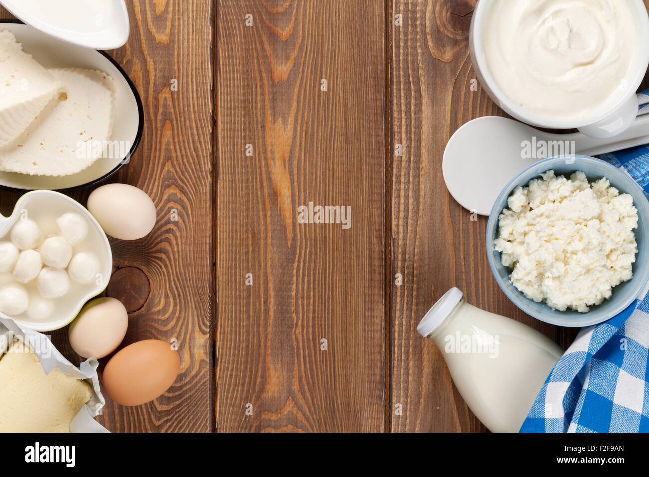 Dairy products on wooden table. Sour cream, milk, cheese, eggs, yogurt ...