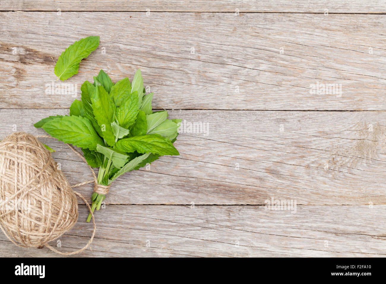 Fresh mint bunch on garden table. Top view with copy space Stock Photo ...