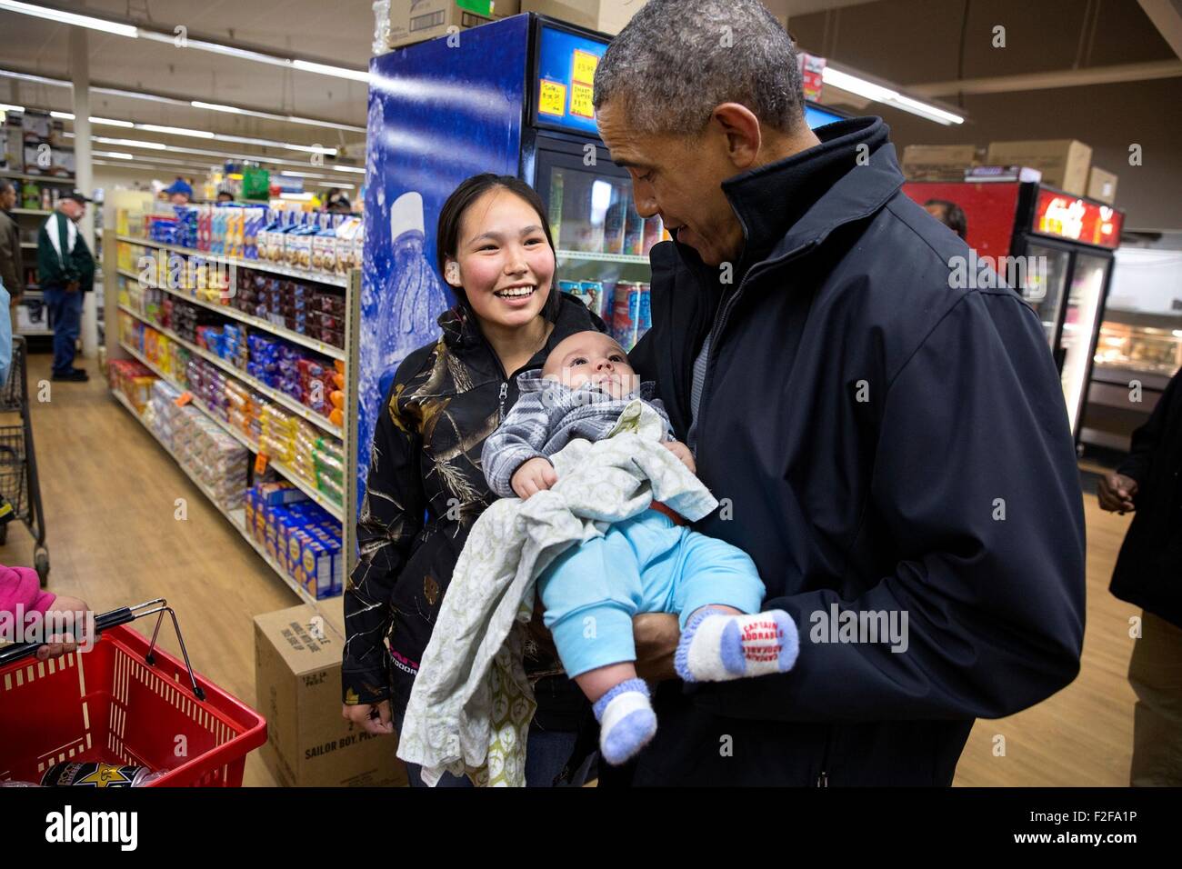 U.S. President Barack Obama holds a Native Alaskan child during a visit ...