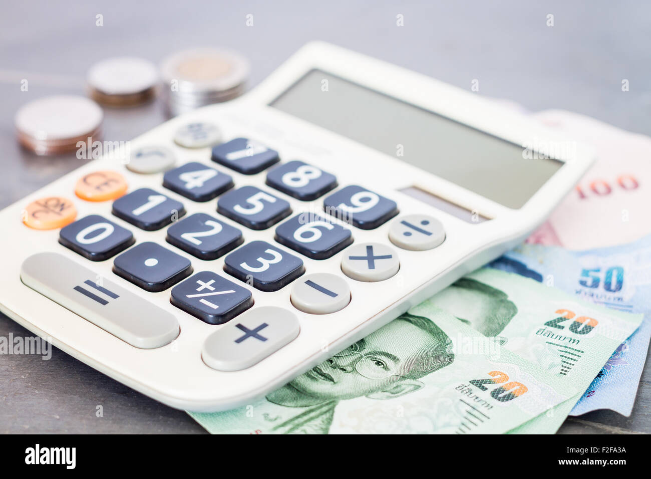 Calculator with money on grey background, stock photo Stock Photo - Alamy