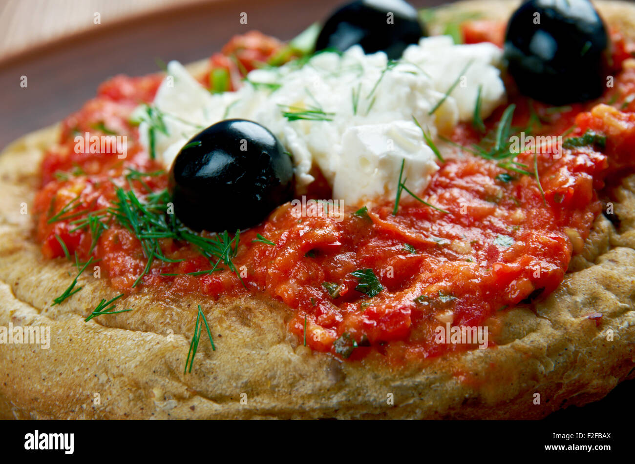 Dakos - slice bread topped with chopped tomatoes and crumbled feta ...