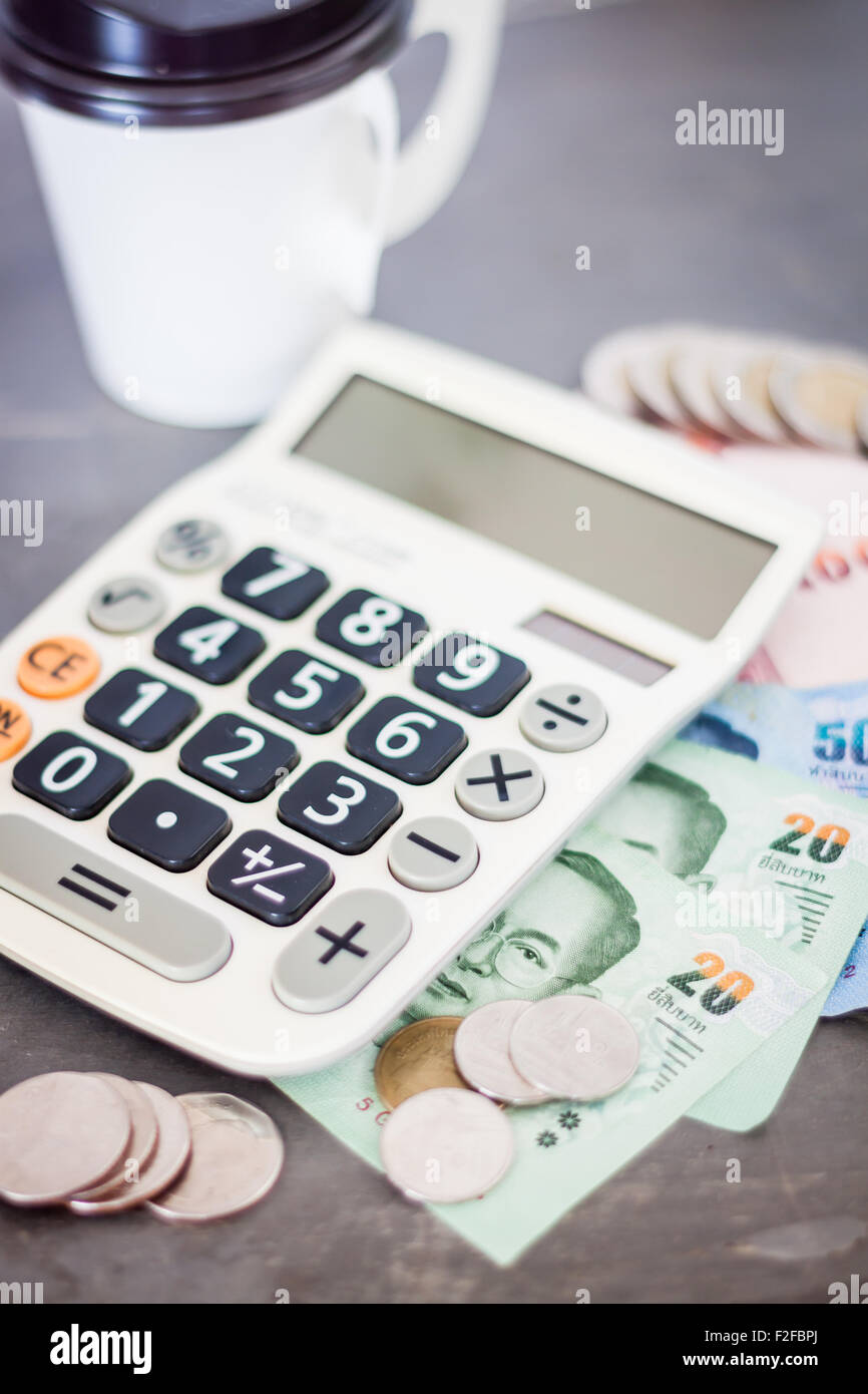 Calculator with money on grey background, stock photo Stock Photo - Alamy