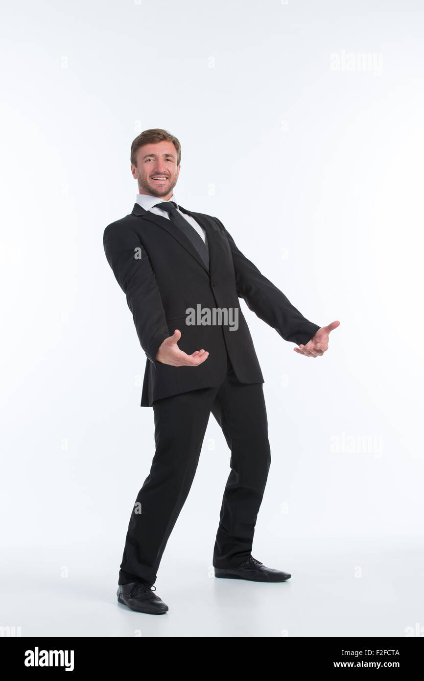 Businessman holding heavy load in front of him Stock Photo - Alamy