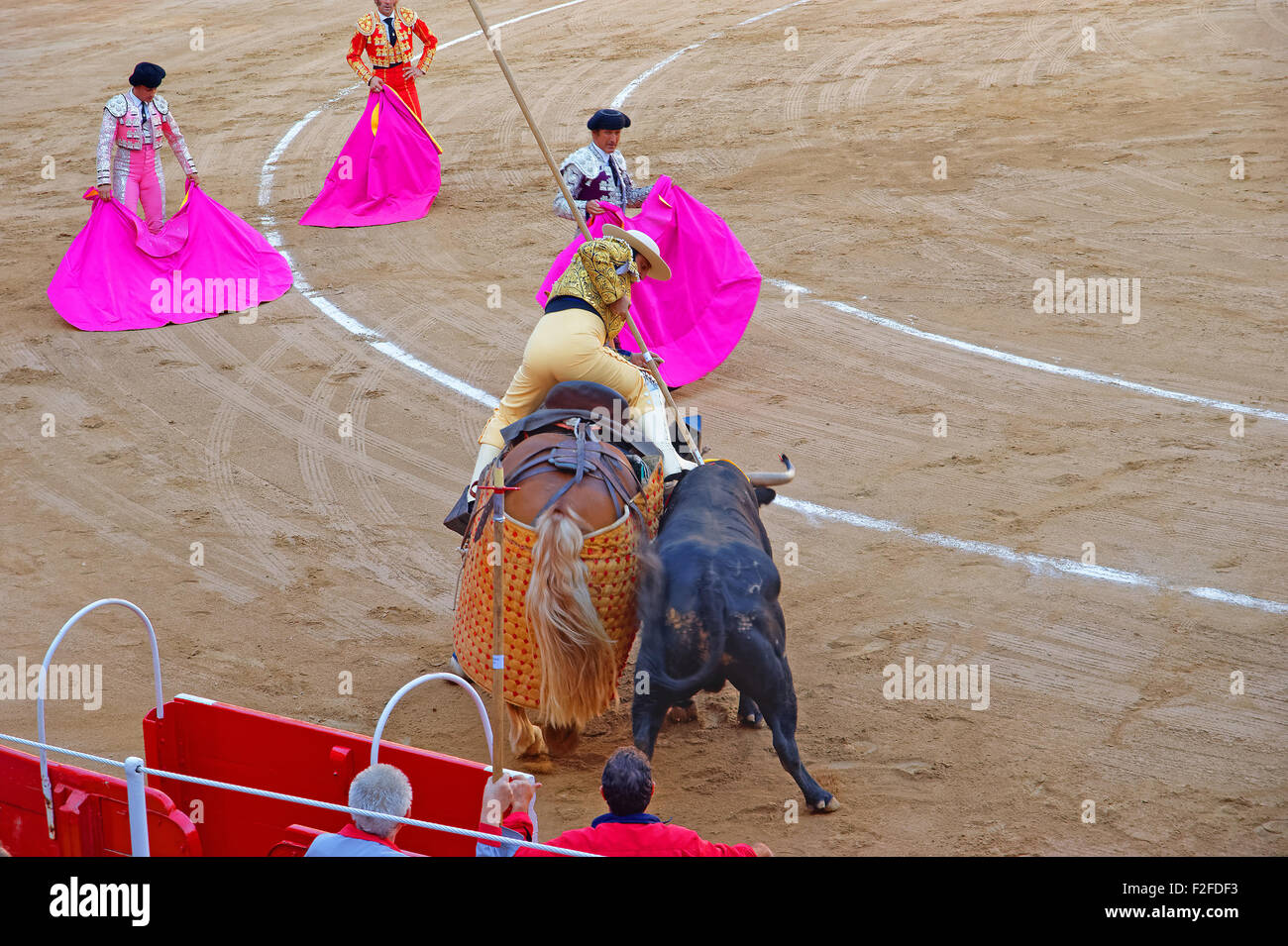 BARCELONA, SPAIN - AUGUST 01, 2010: Lancer (bullfighter) wounds a bull ...