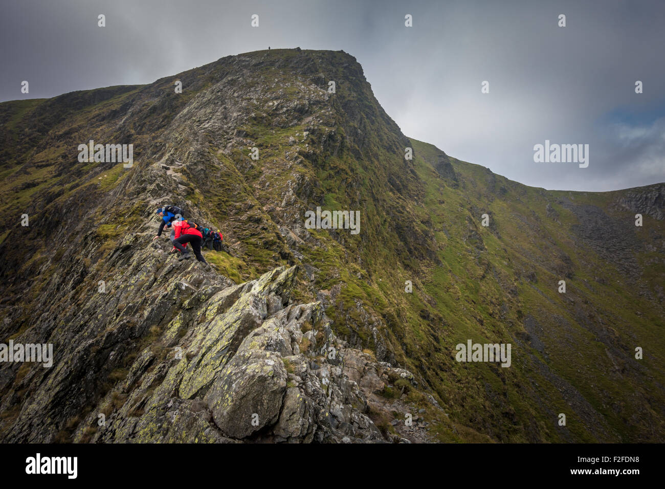 Men socialising - People scrambling up Sharp Edge, a Grade 1 scramble ...