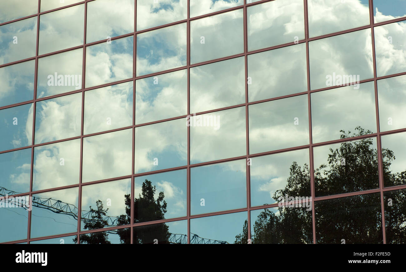Clouds reflected in windows of modern office building Stock Photo - Alamy