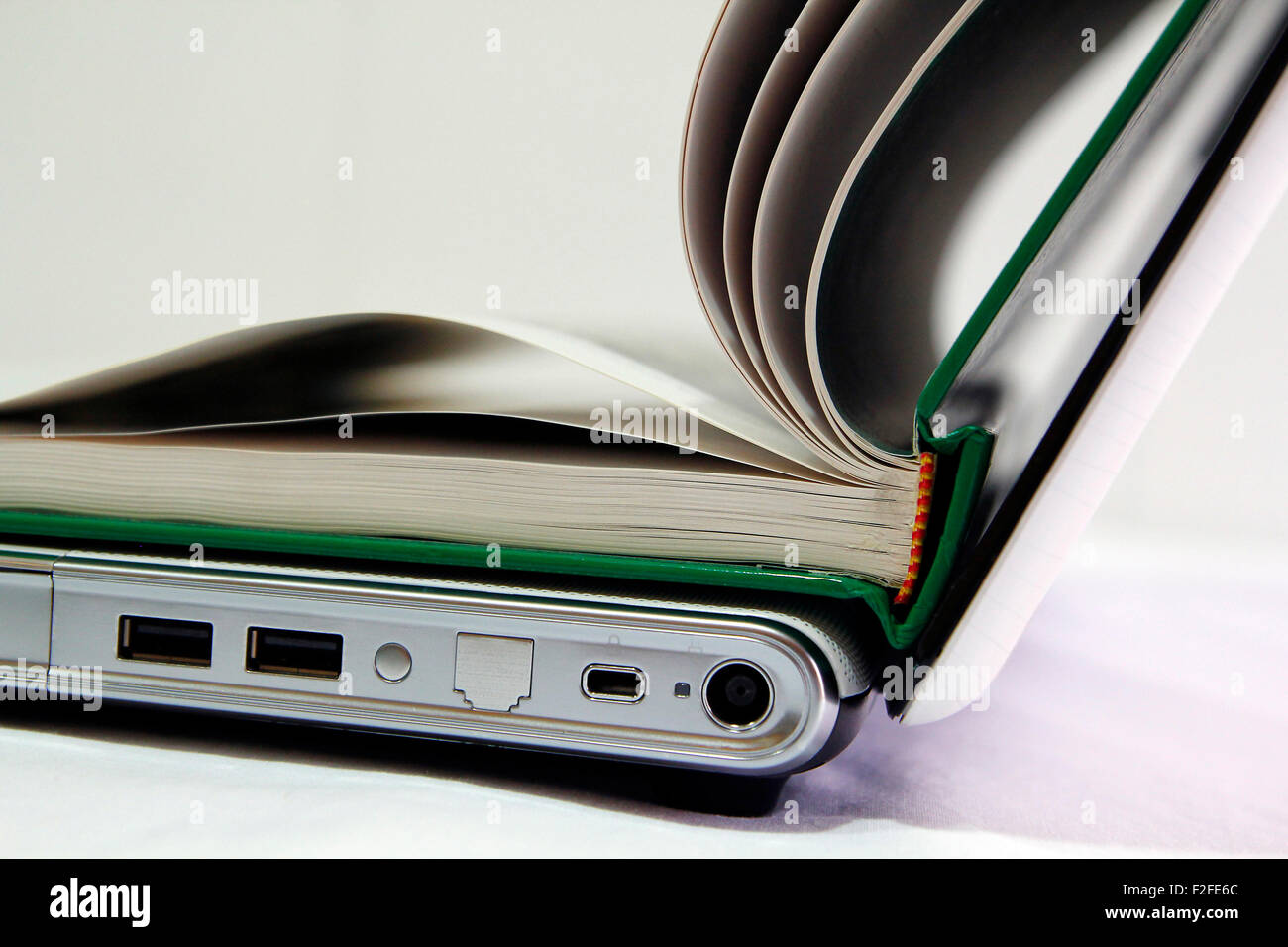 Open book over a laptop Stock Photo - Alamy