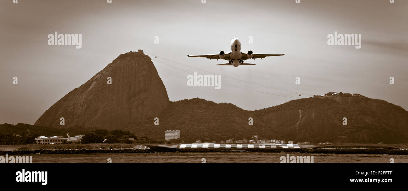 A plane taking into air over Rio de Janeiro with the Sugarloaf mountain ...