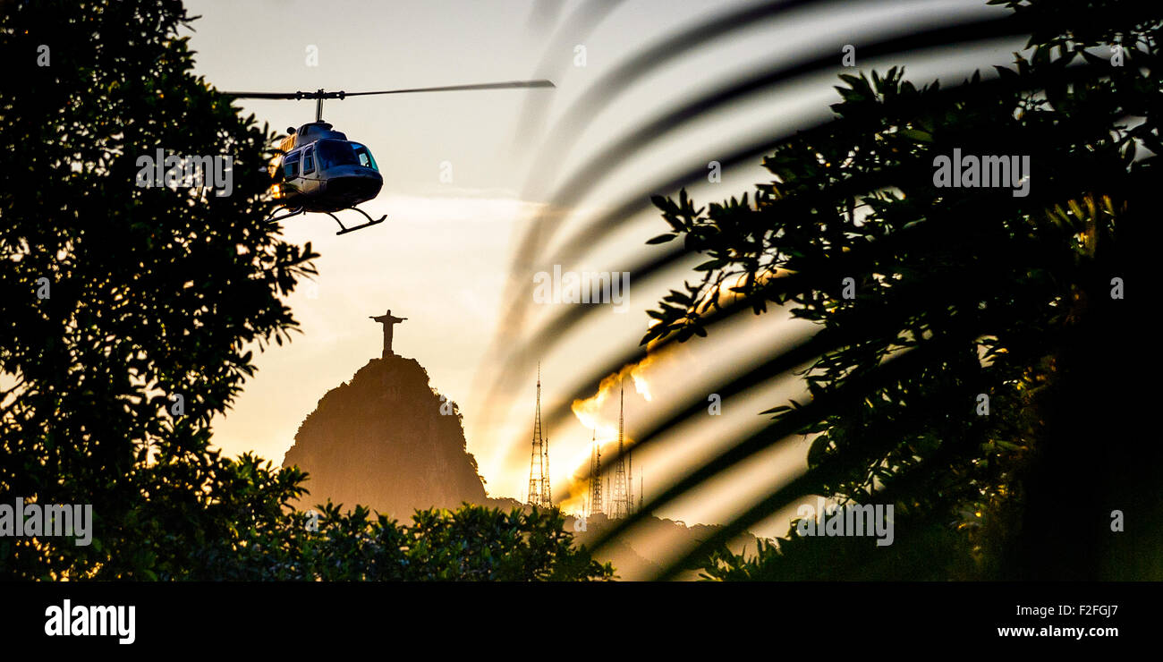 Helicopter flying in the sky with Christ The Redeemer statue in the ...
