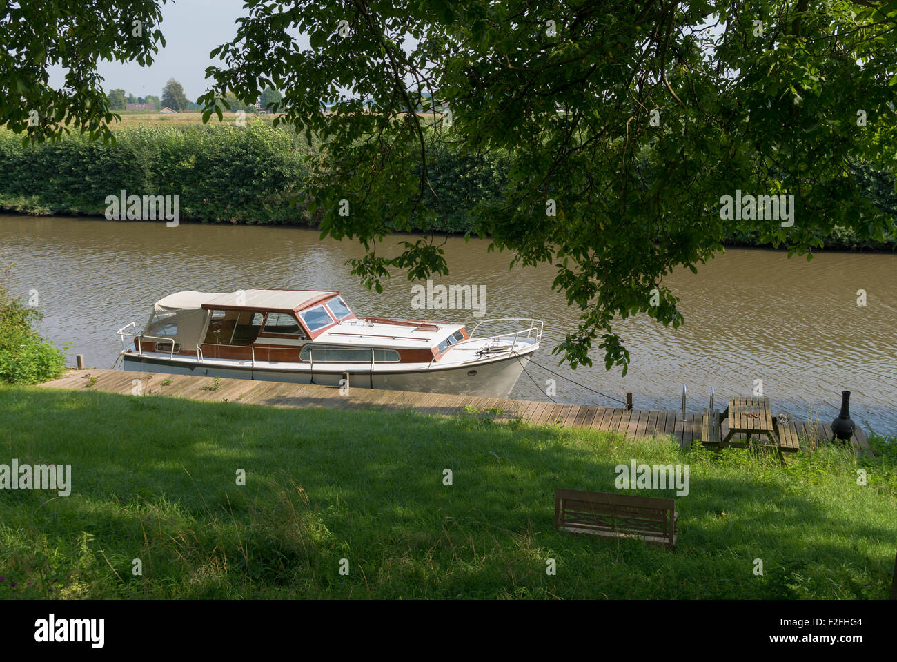 small motor boat in a canal in the netherlands Stock Photo - Alamy