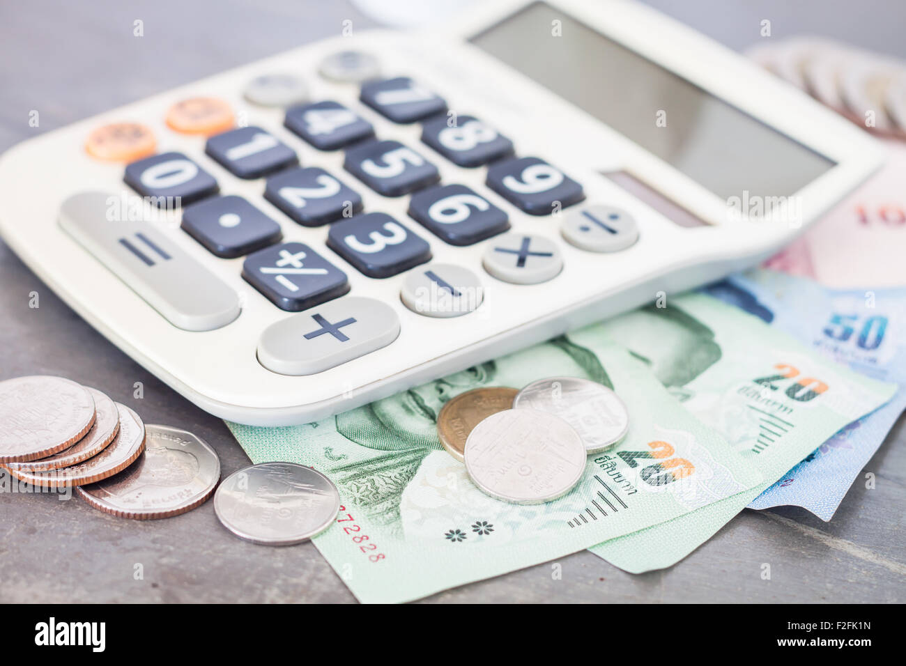 Calculator with money on grey background, stock photo Stock Photo - Alamy