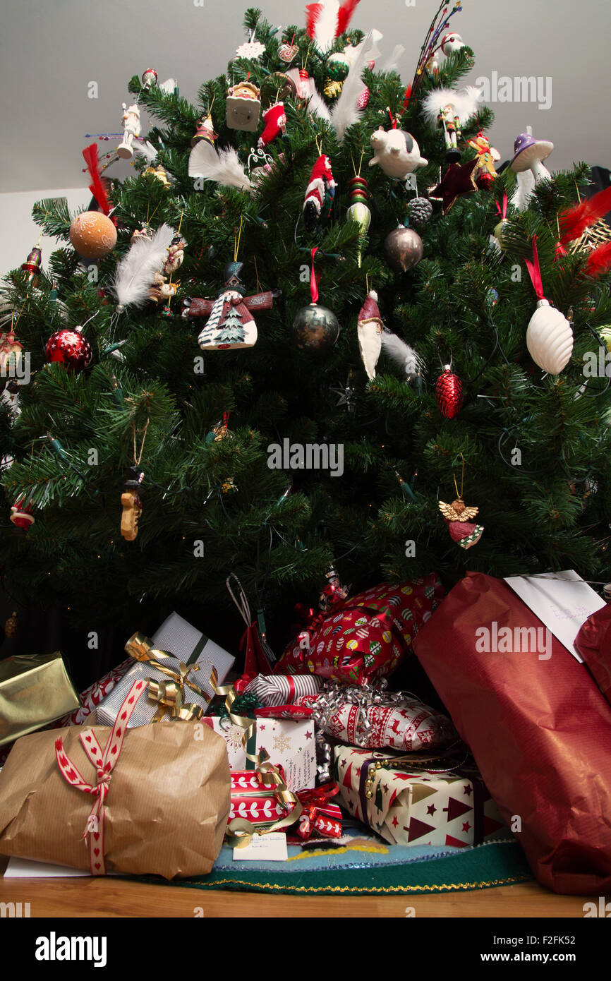 Christmas presents under a christmas tree, shot from below with a wide ...