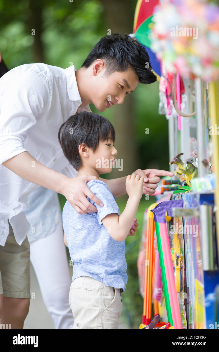 Father and son buying toys Stock Photo - Alamy